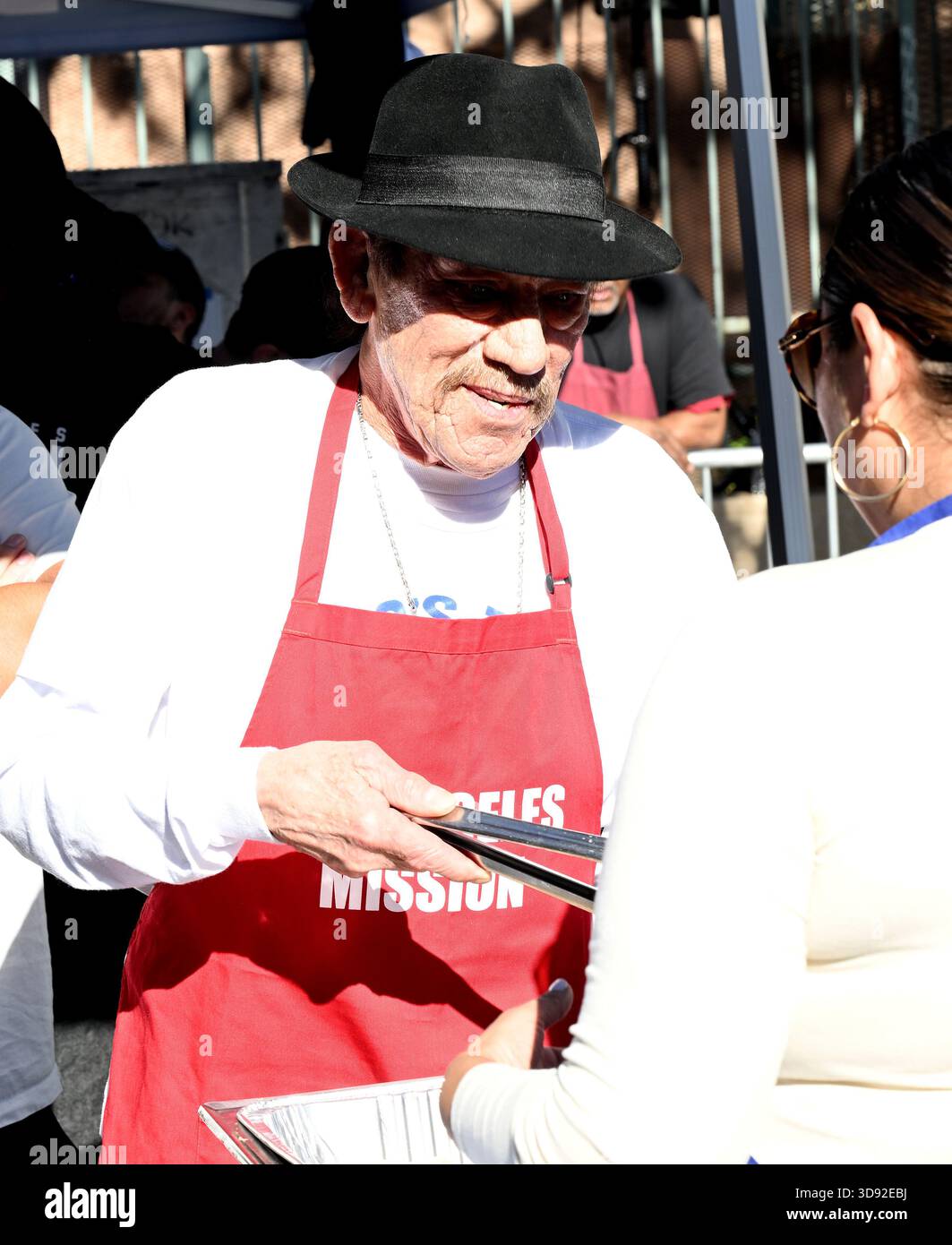 Actor Danny Trejo serves free lunch to the homeless at the LA Mission ...