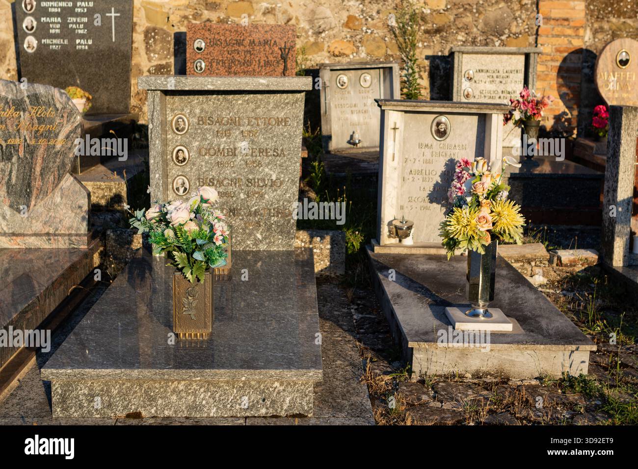 Italian cemetery landscape with historic graves decorated with flowers ...