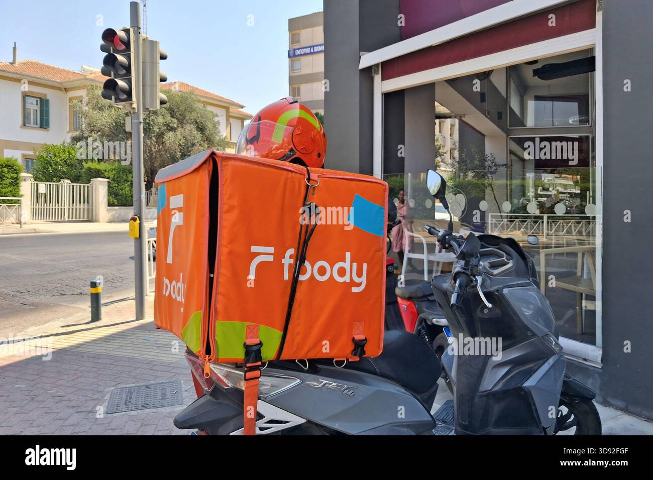Larnaca, Cyprus - August 05 2025: Motor Scooter with a thermal delivery ...