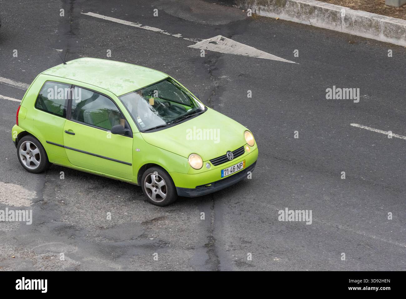 Volkswagen lupo compact car driving on a road with an arrow marking ...