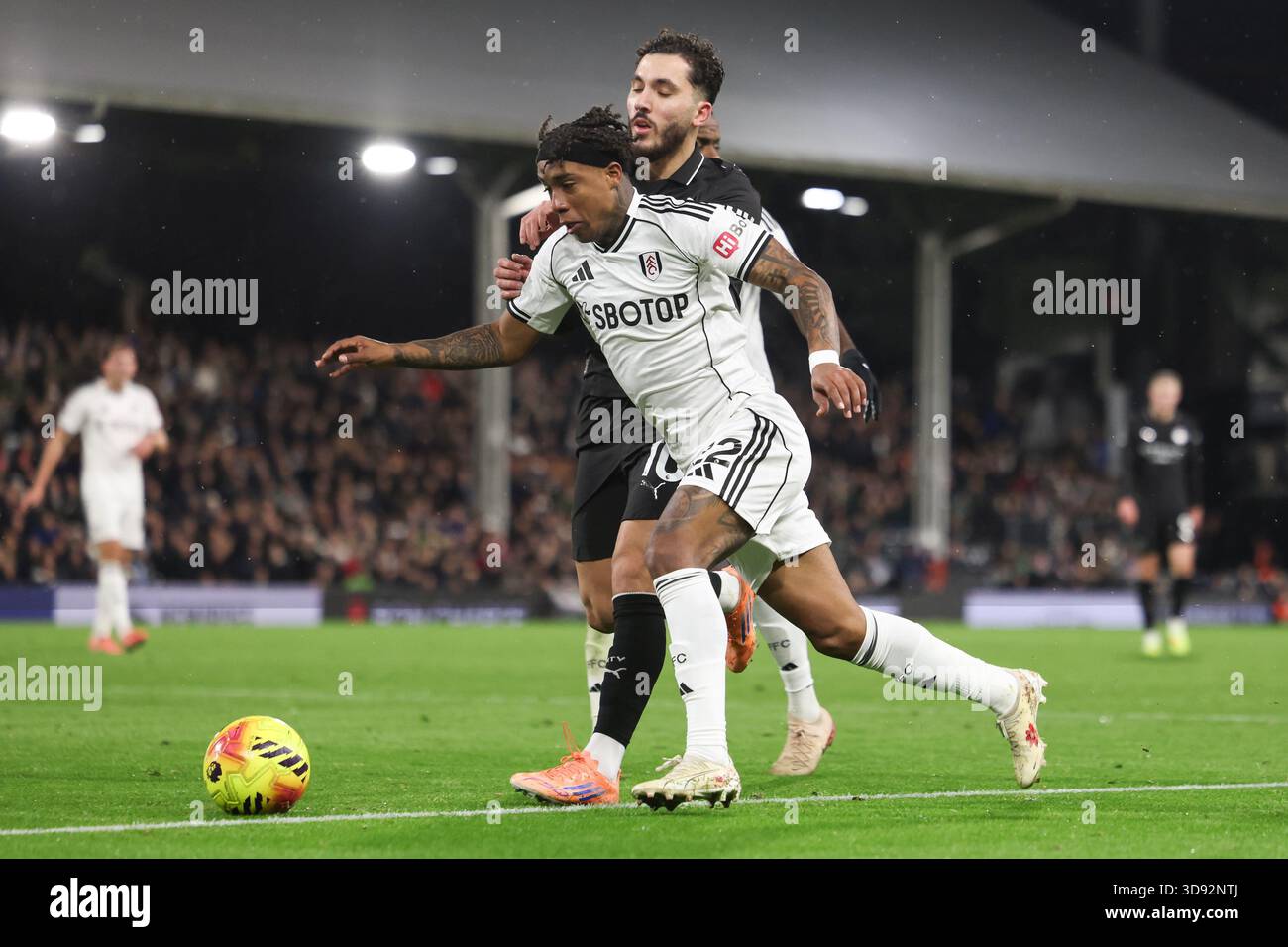 Fulham midfielder Kevin (22) is challenged by Manchester City midfielder Rayan Cherki (10 ...