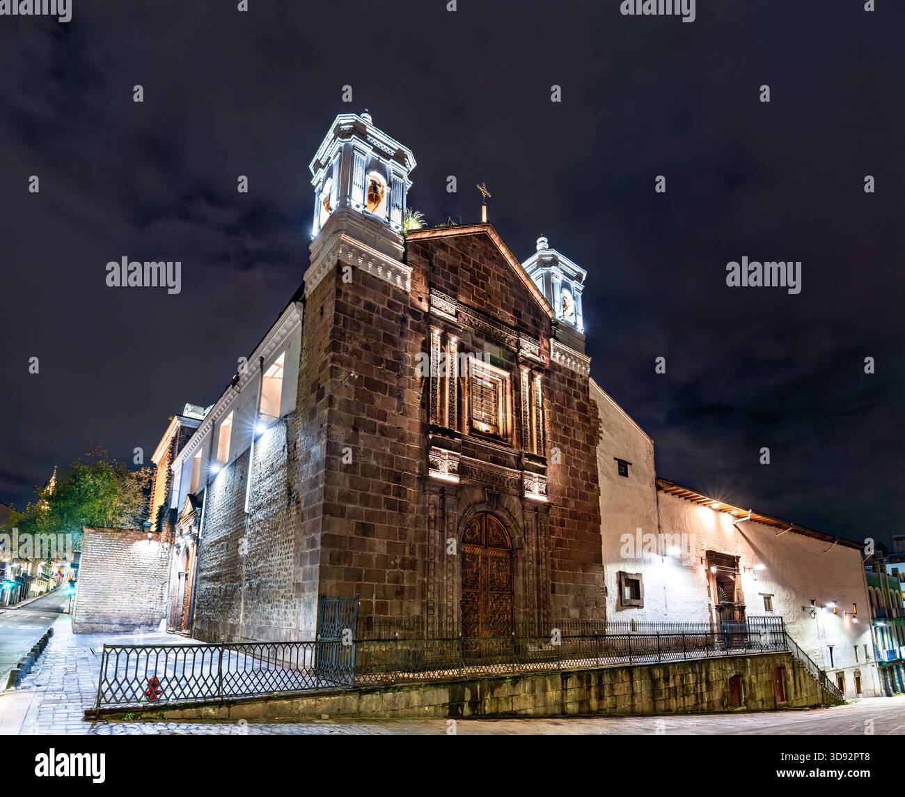 Stone facade of El Carmen Bajo church glows under night sky in Quito ...
