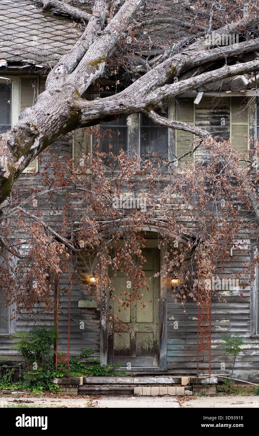 Close up on front door of dilapidated abandoned two-story home with ...
