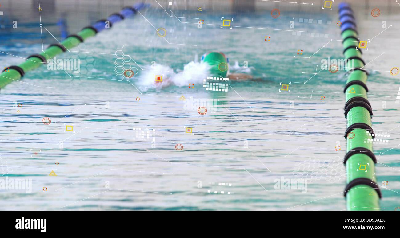 Cutting swimmer in green cap goggles suit powering through lane at pool ...