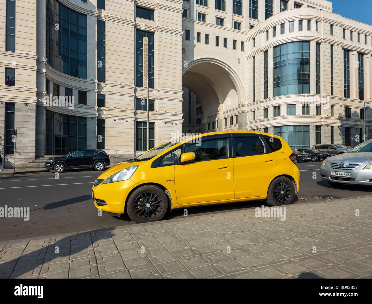 Yerevan Armenia 11.25.2025. A yellow car is parked on the side of the ...