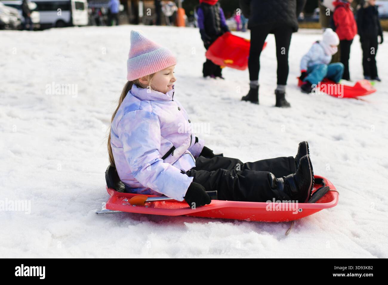 Happy girl sledding down hi-res stock photography and images - Alamy