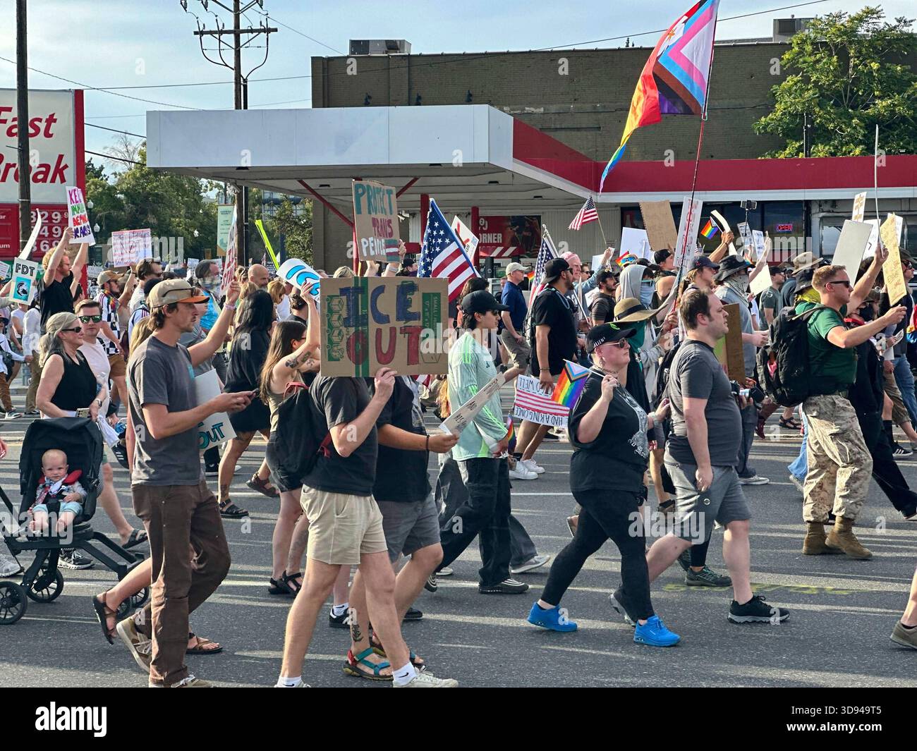 FILE - Demonstrators carry signs and chant while marching during a "No ...