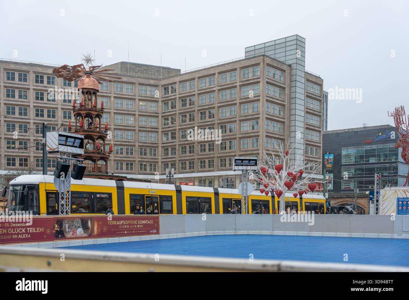 Germany Berlin December 3, 2025. City ice rink with a tram passing by ...