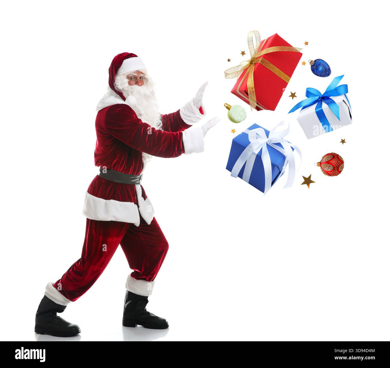 Santa Claus levitating Christmas balls and gift boxes on white ...
