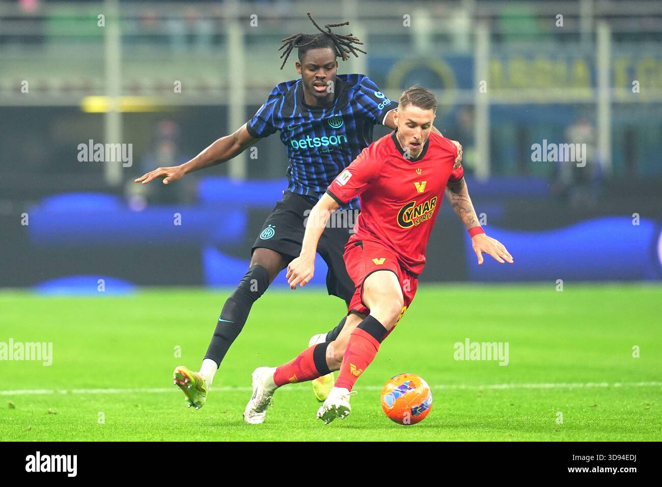 Inter Milan's Yann Bisseck fights for the ball with Venezia’s Antonio ...