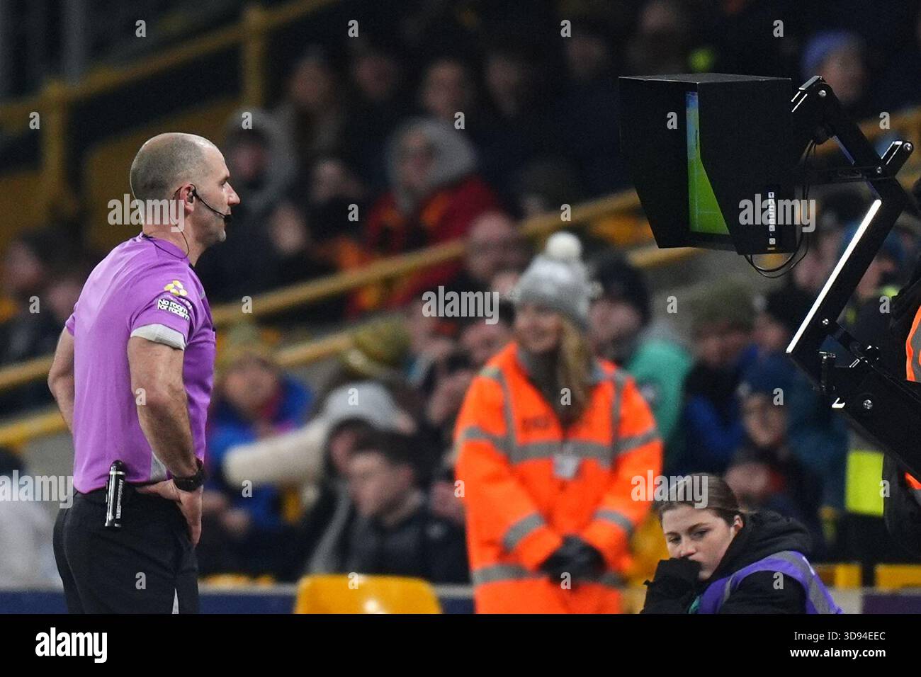 Referee Tim Robinson looks at the on pitchside VAR screen before ruling ...