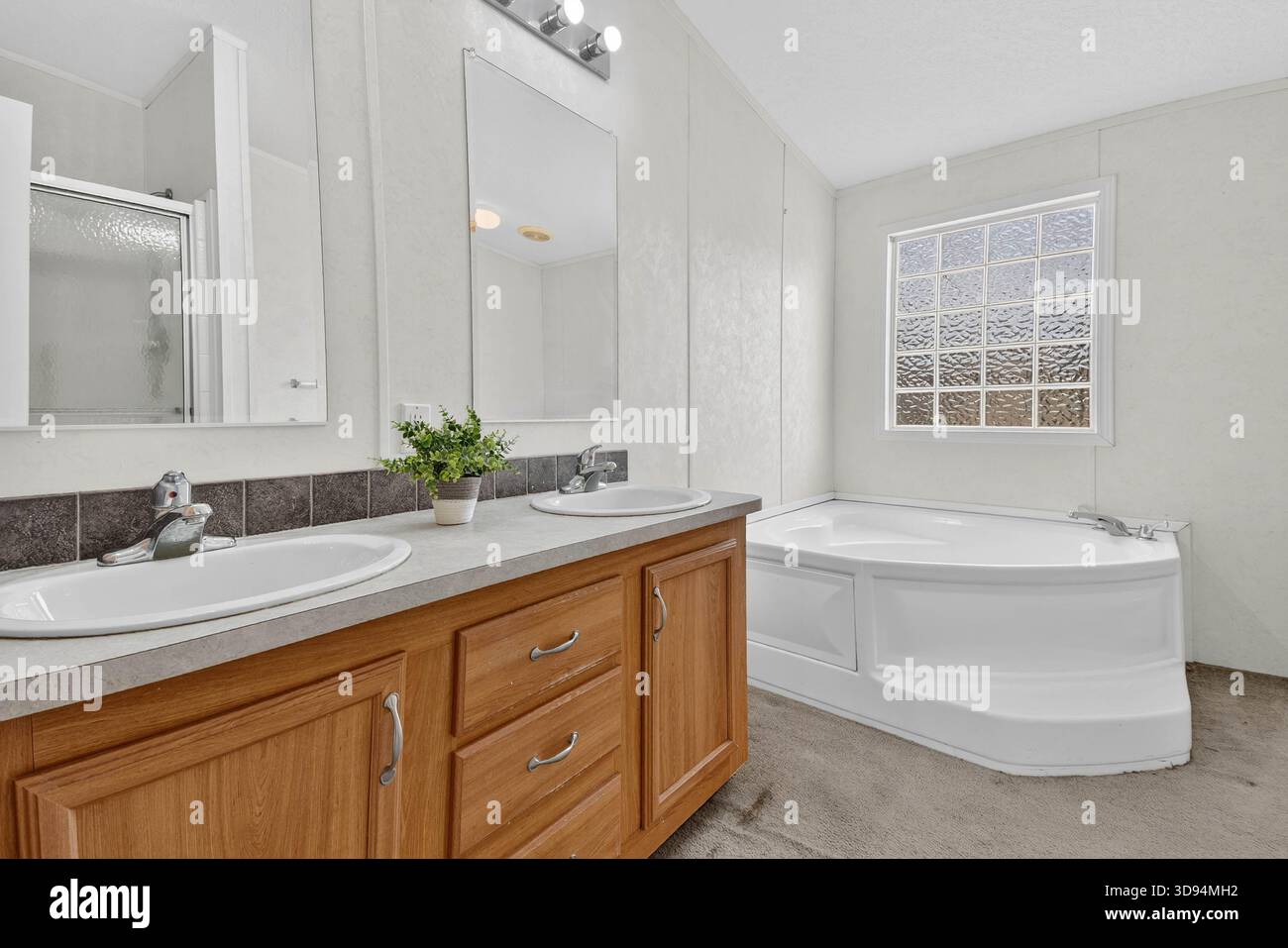 Expansive Bathroom Area Featuring Soaking Tub In Corner And Dual Vanity ...