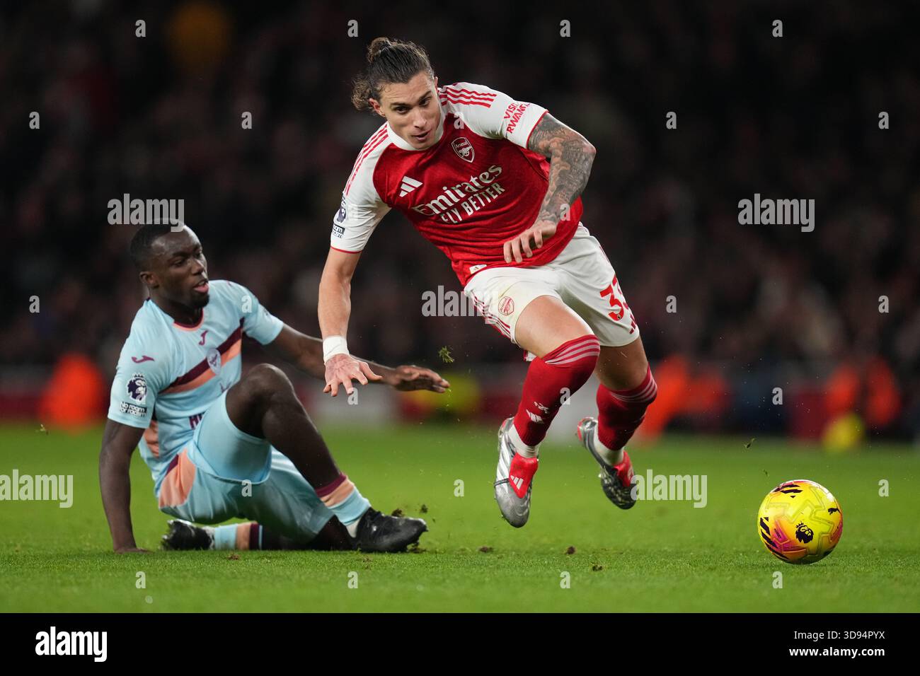 Brentford's Michael Kayode tackles Arsenal's Riccardo Calafiori during ...