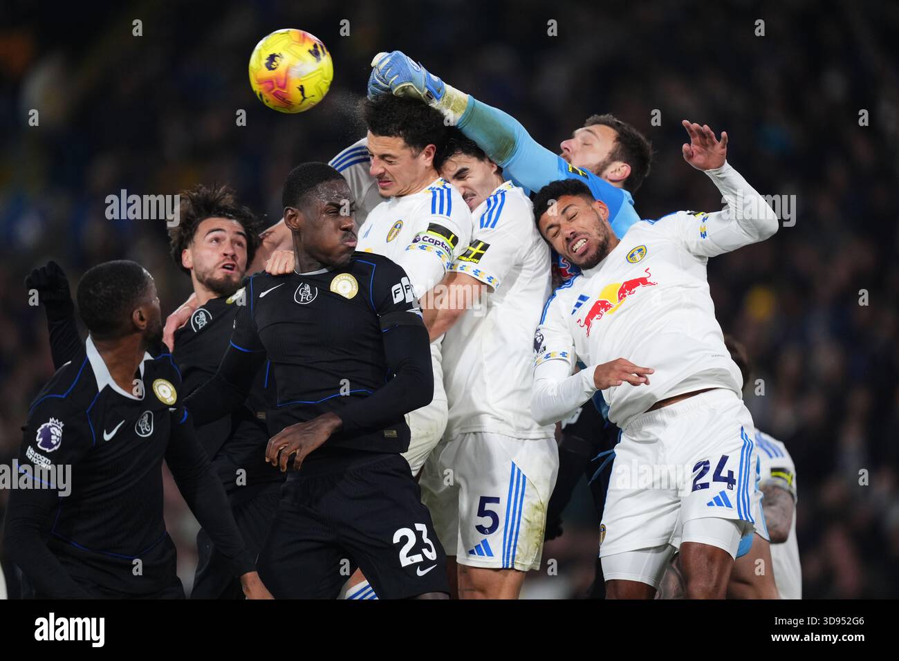 Leeds United goalkeeper Lucas Perri (second right) punches the ball ...