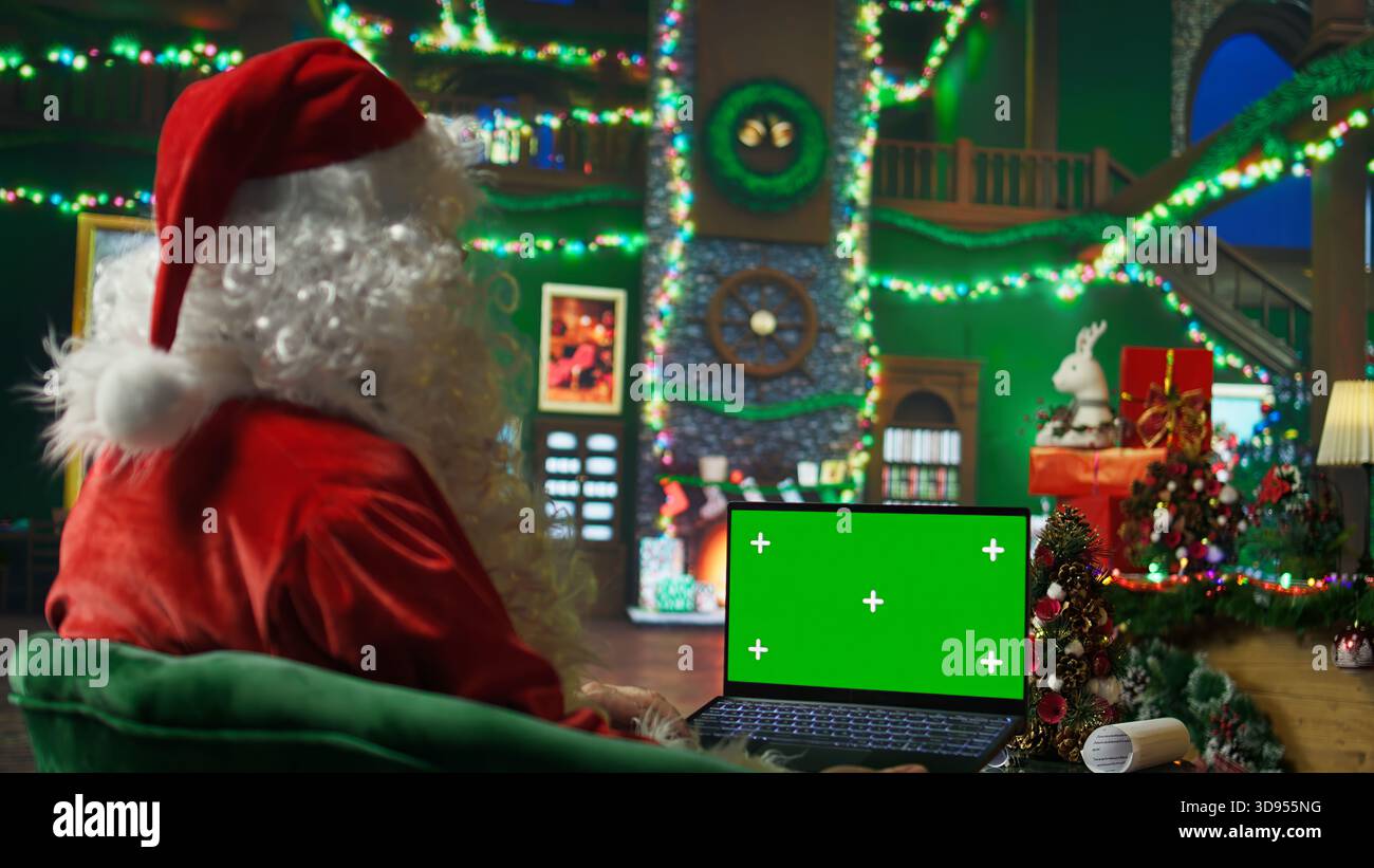 Santa Claus responding to kids requesting gifts, typing on green screen ...