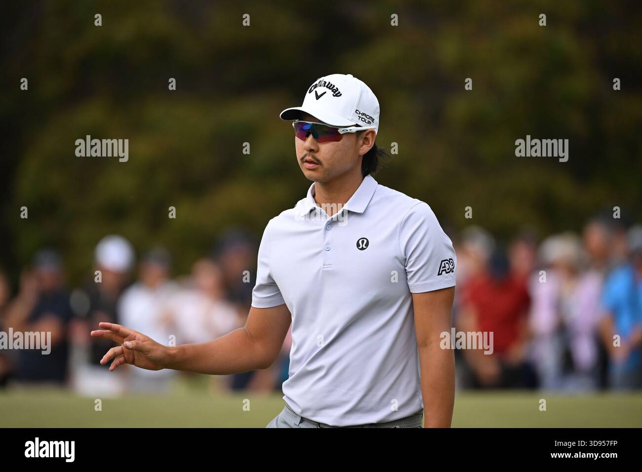 Min Woo Lee of Australia reacts after playing a shot in round one of ...