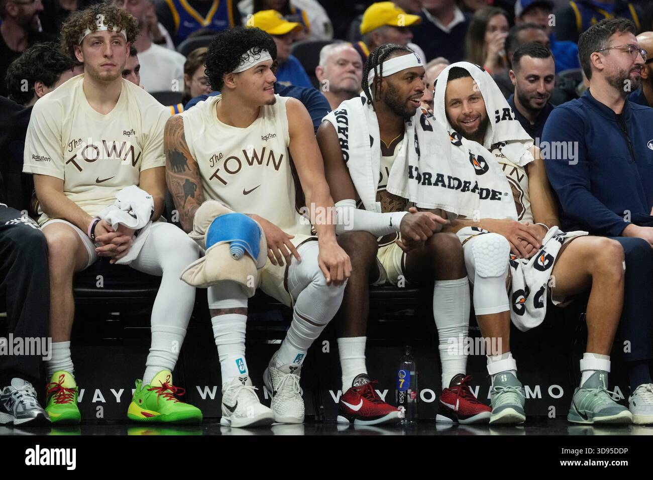 Golden State Warriors guard Brandin Podziemski, from left, sits on the ...