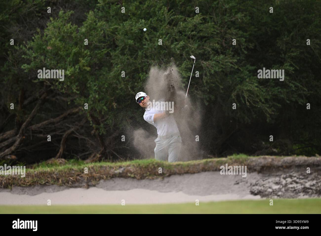 Min Woo Lee of Australia plays a shot in round one of the Australian ...