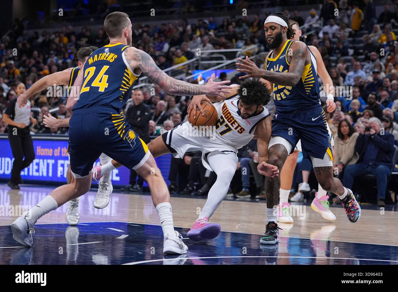 Denver Nuggets guard Jamal Murray (27) falls as he cuts between Indiana ...
