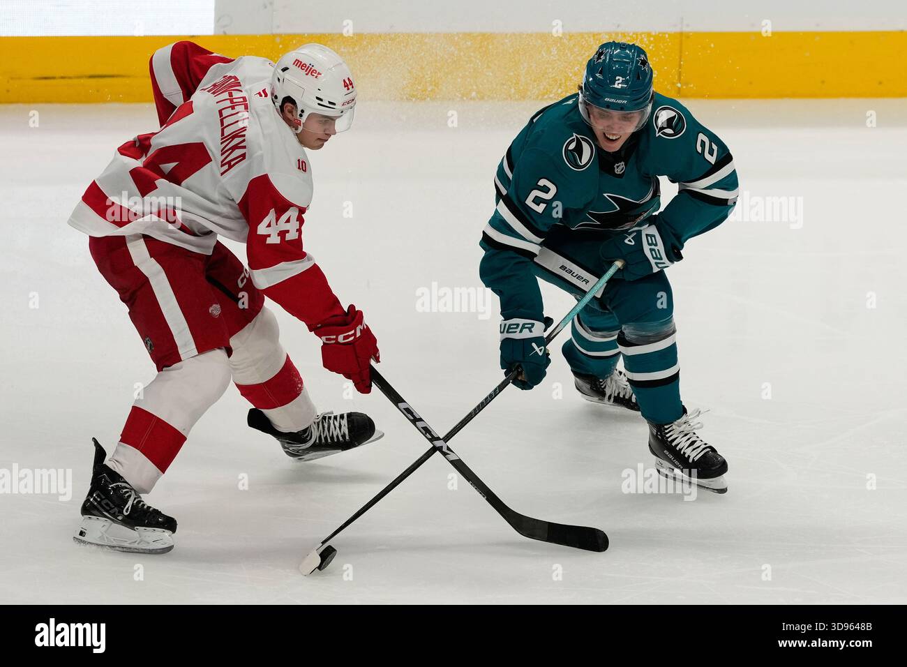 San Jose Sharks center Will Smith (2) reaches for the puck next to Detroit Red Wings defenseman ...