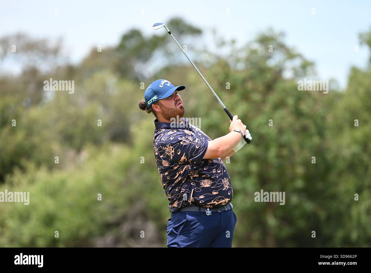 Corey Lamb of Australia plays a shot on the 18th hole in round one of ...