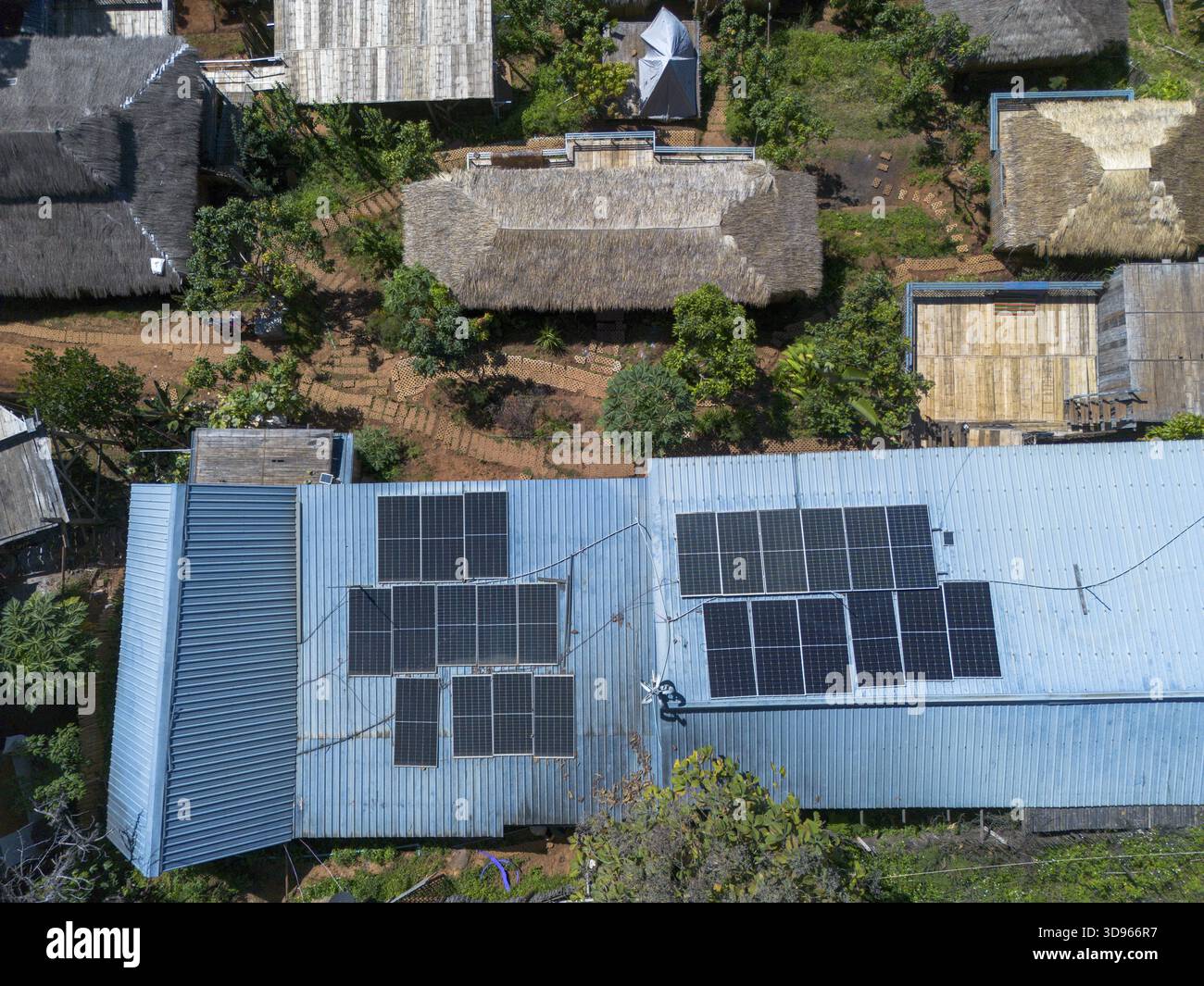 Aerial view of rural village with solar panel on roof, symbol of ...