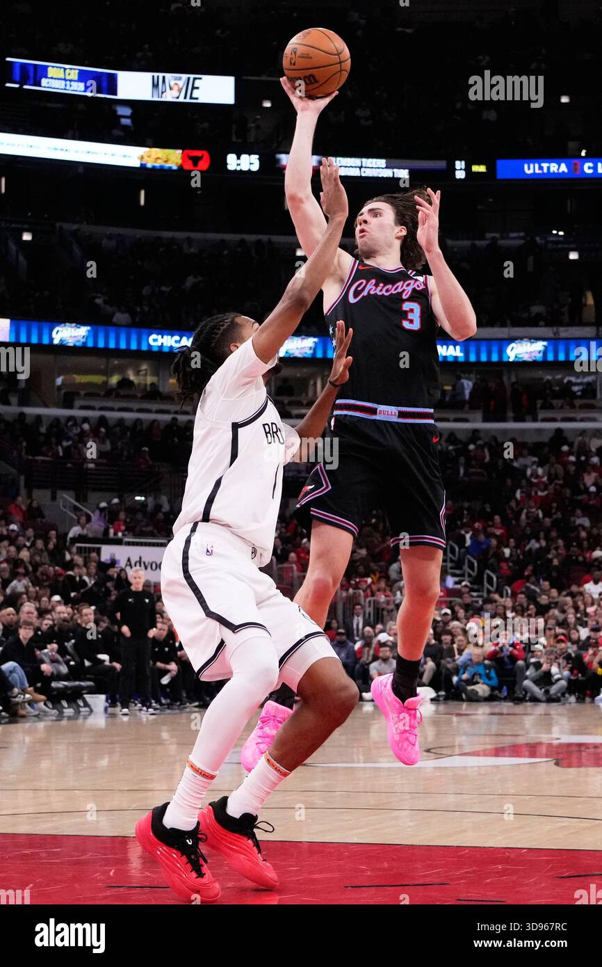 Chicago Bulls guard Josh Giddey, right, goes up for a shot against ...