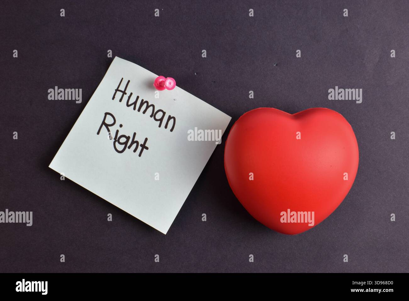 Heart-shaped object beside pinned Human Right note visual metaphor ...