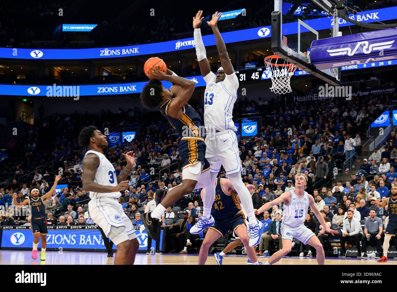Brigham Young center Keba Keita, center right, goes up to block the ...
