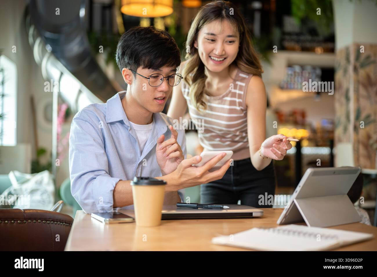 Woman bending over table hi-res stock photography and images - Alamy