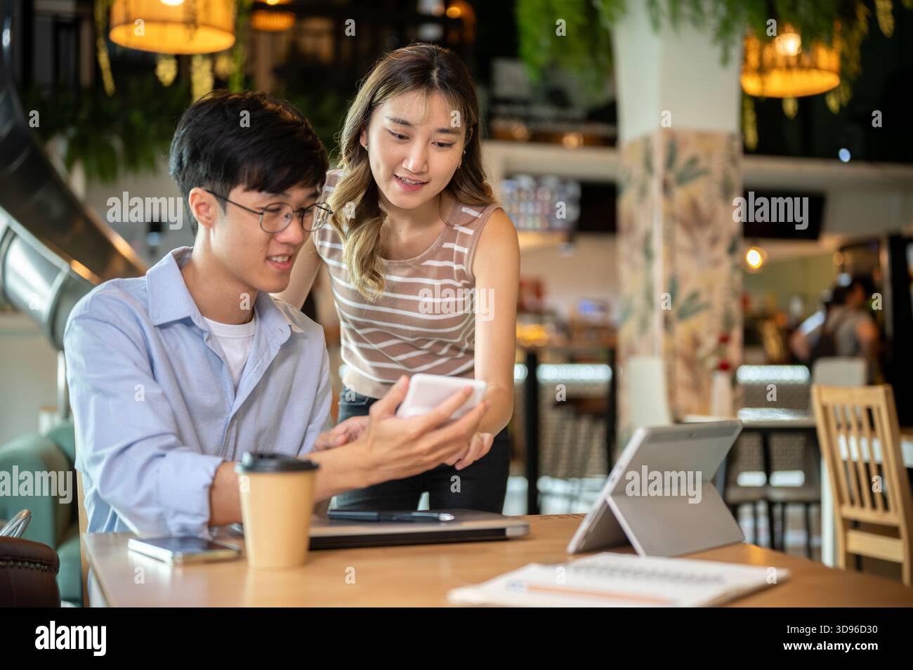 Woman bending over table hi-res stock photography and images - Alamy
