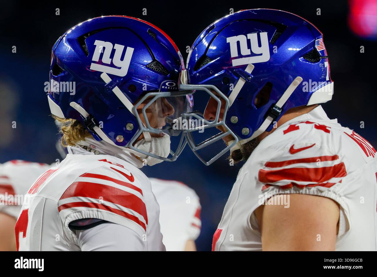 New York Giants quarterback Jaxson Dart (6) bumps helmets with guard ...
