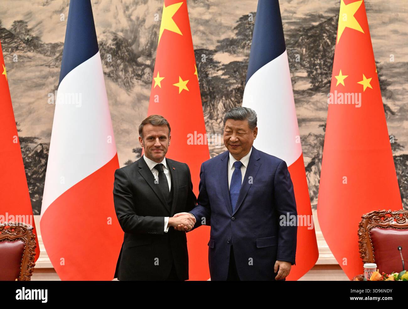 France's President Emmanuel Macron, left, shakes hands with China's ...