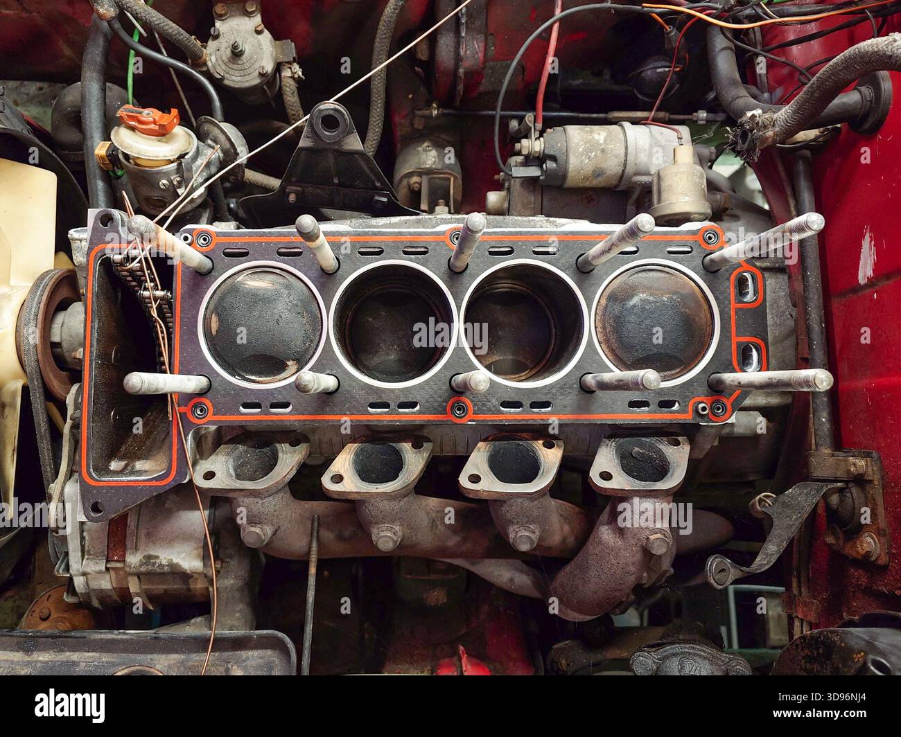 Open, inline four engine block with head gasket, exposed cylinders with ...