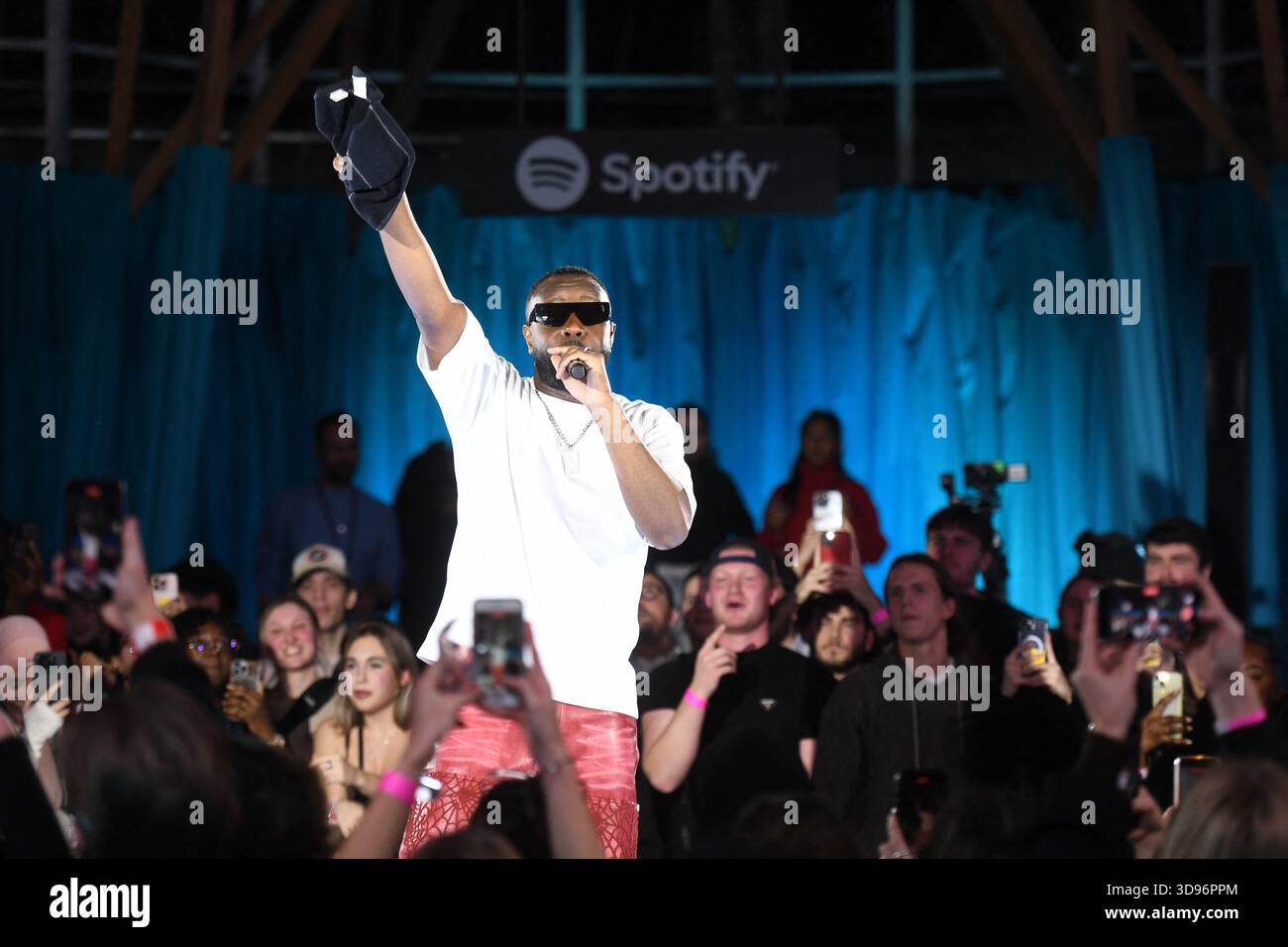 Gims performing at a surprise concert for his fans to celebrate his ...
