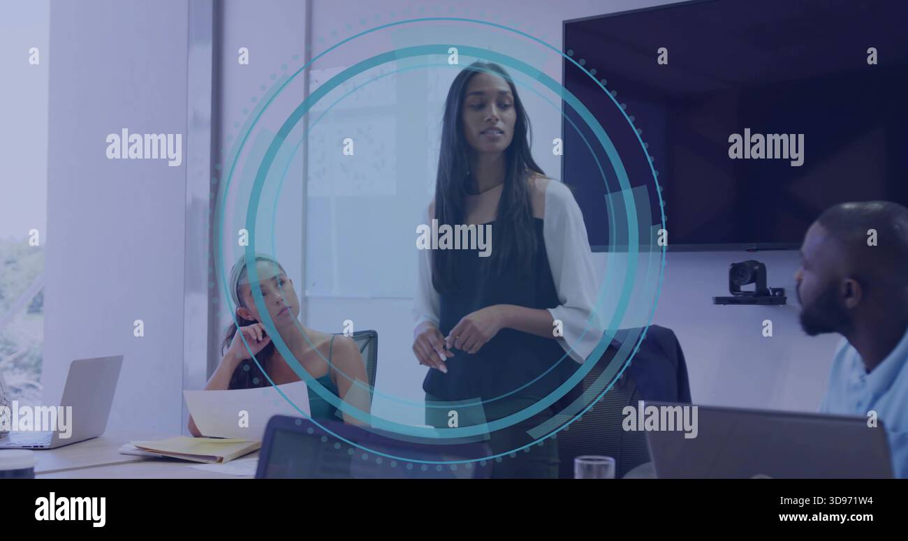 Presenting woman in black dress speaking with team in meeting room with ...