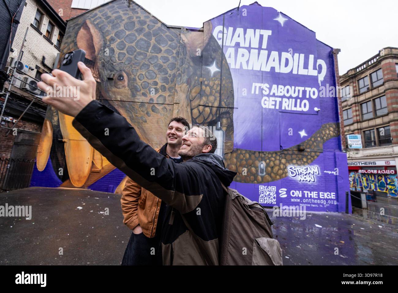EDITORIAL USE ONLY Alex Bowmer (left) and Rob Slade take a selfie with a mural to celebrate the ...