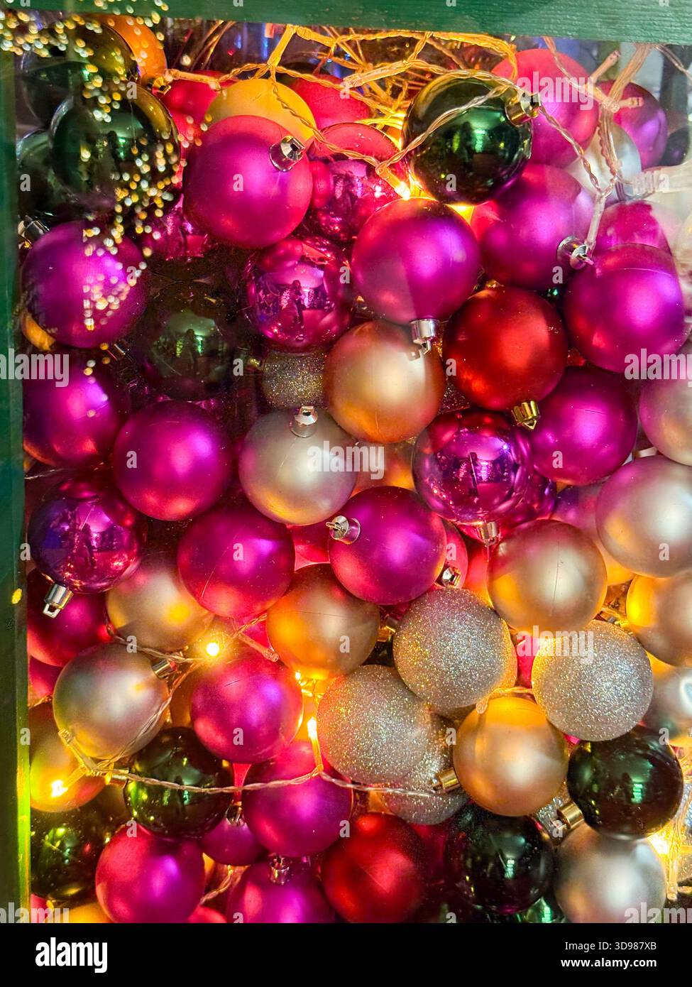 Christmas box filled with colorful baubles and festive lights creating ...