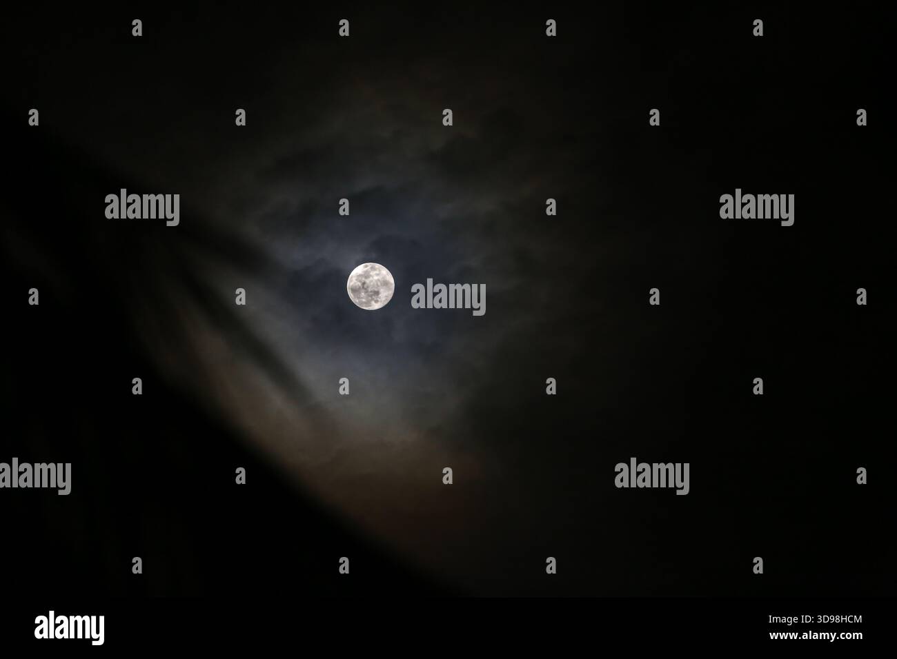 Phnom Penh, Cambodia. 4th Dec, 2025. Full moon over a suburban area of ...