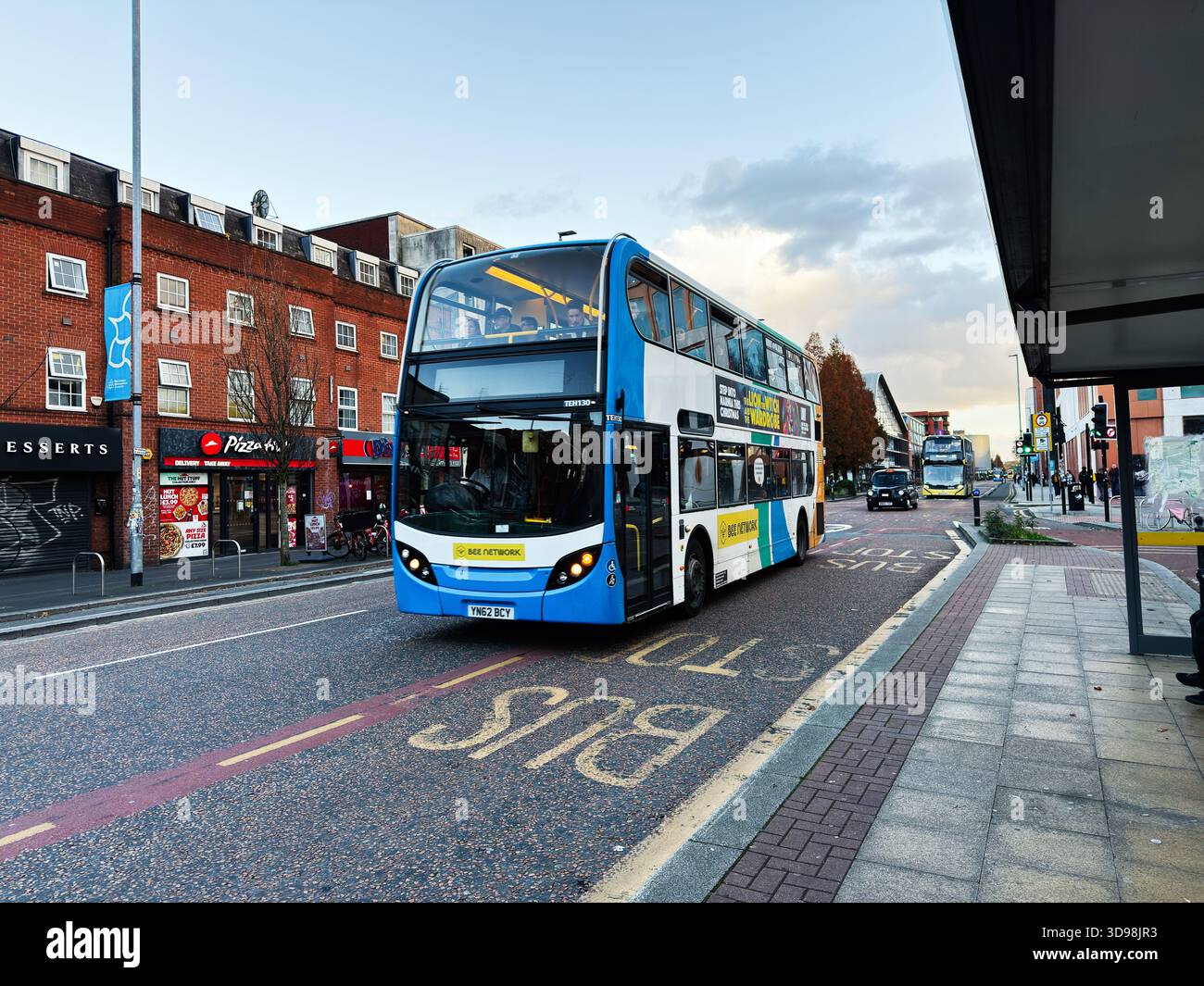 Manchester, UK - November 08, 2025: A blue double decker bus navigates ...