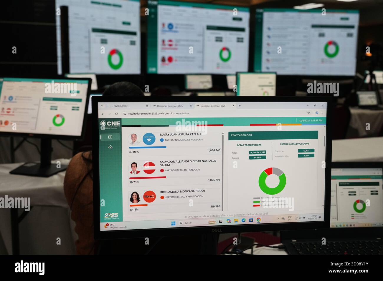 Screens show the results of the ongoing vote count of Sunday's ...