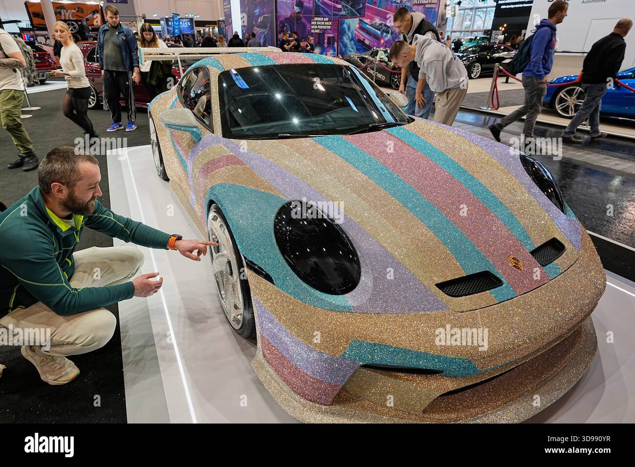 Visitors watch a shining Porsche sports car covered by 1.2 million ...