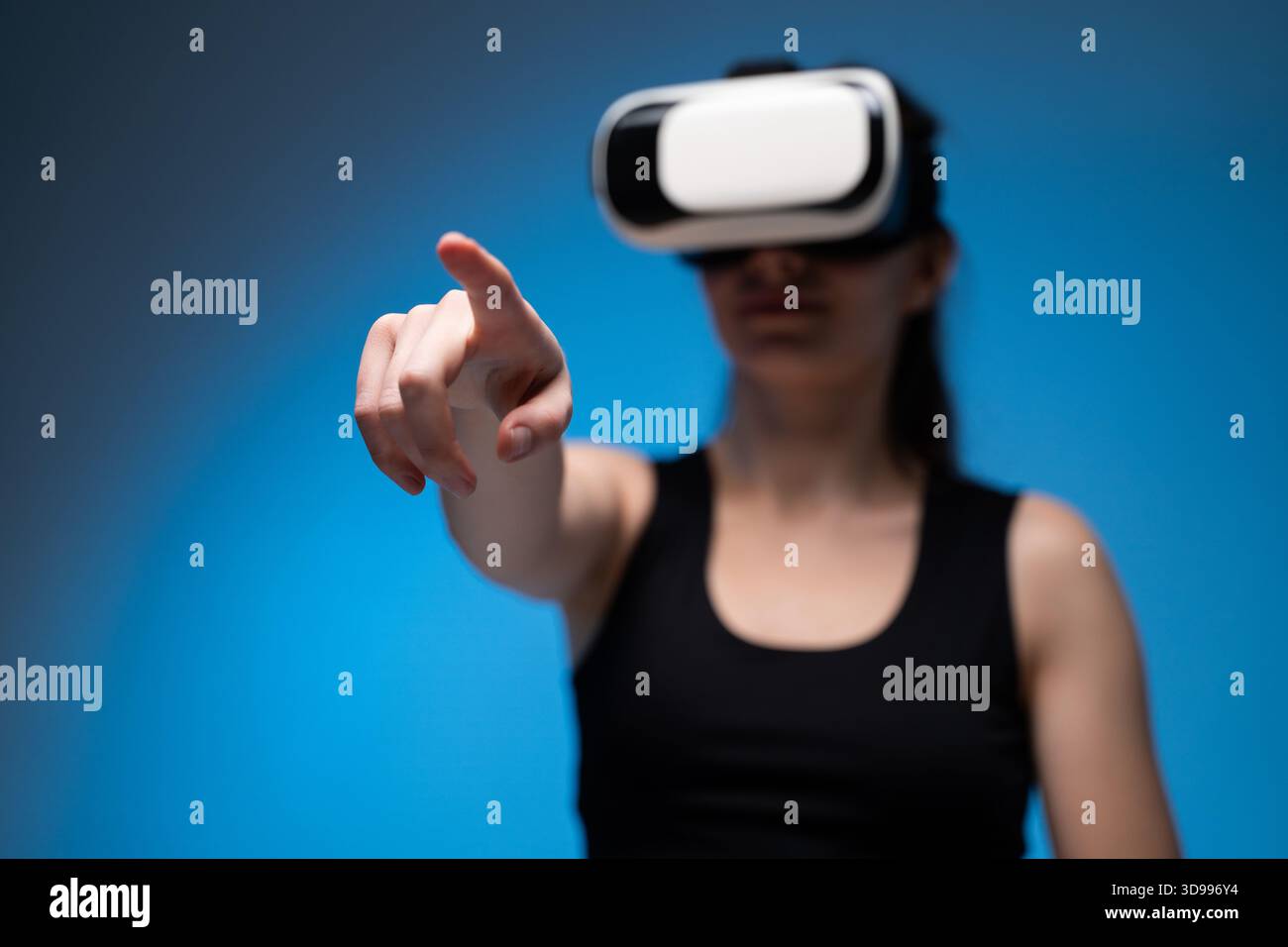 VR designer interacting with virtual workspace by pointing forward ...