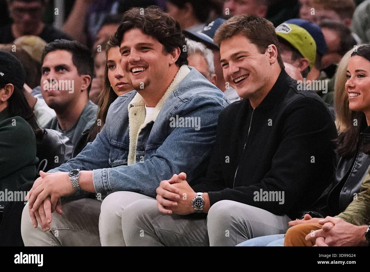 FILE - New England Patriots quarterback Drake Maye, right, sits with ...