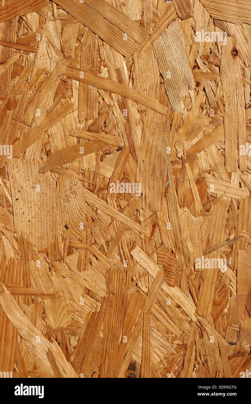 A close view of a wood panel made from pressed wood strands shows ...