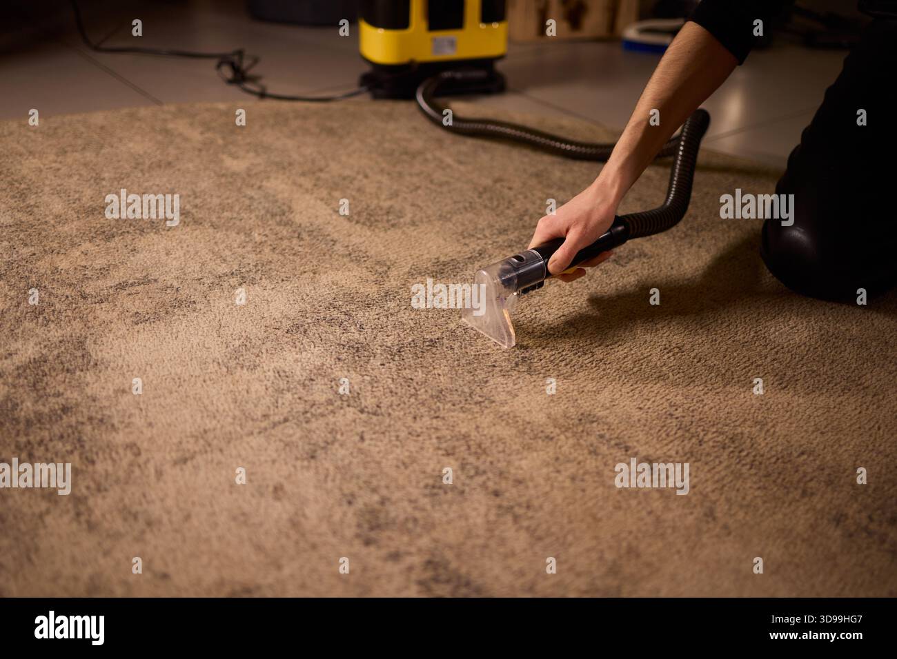 Maintenance technician performs thorough carpet extraction ...