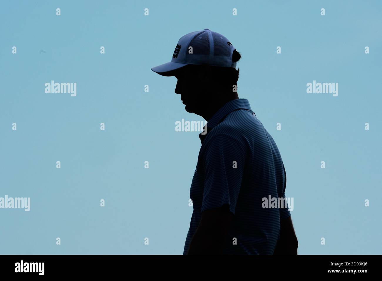 Harris English, of the United States, studies his putt on the third ...