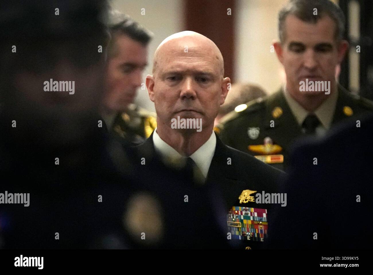 U.S. Navy Adm. Frank M. Bradley walks along a hallway after a meeting ...
