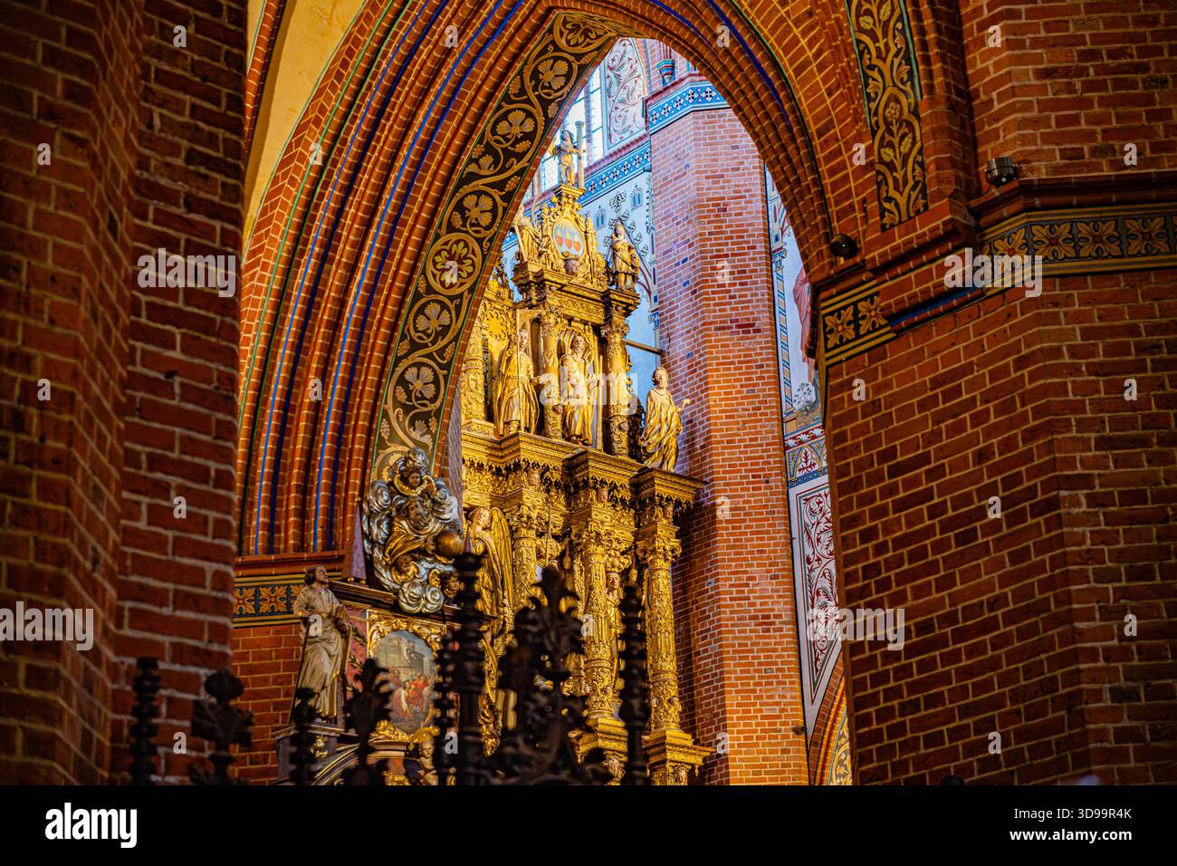 Elaborate golden Baroque altar with crucifix and religious statues in ...