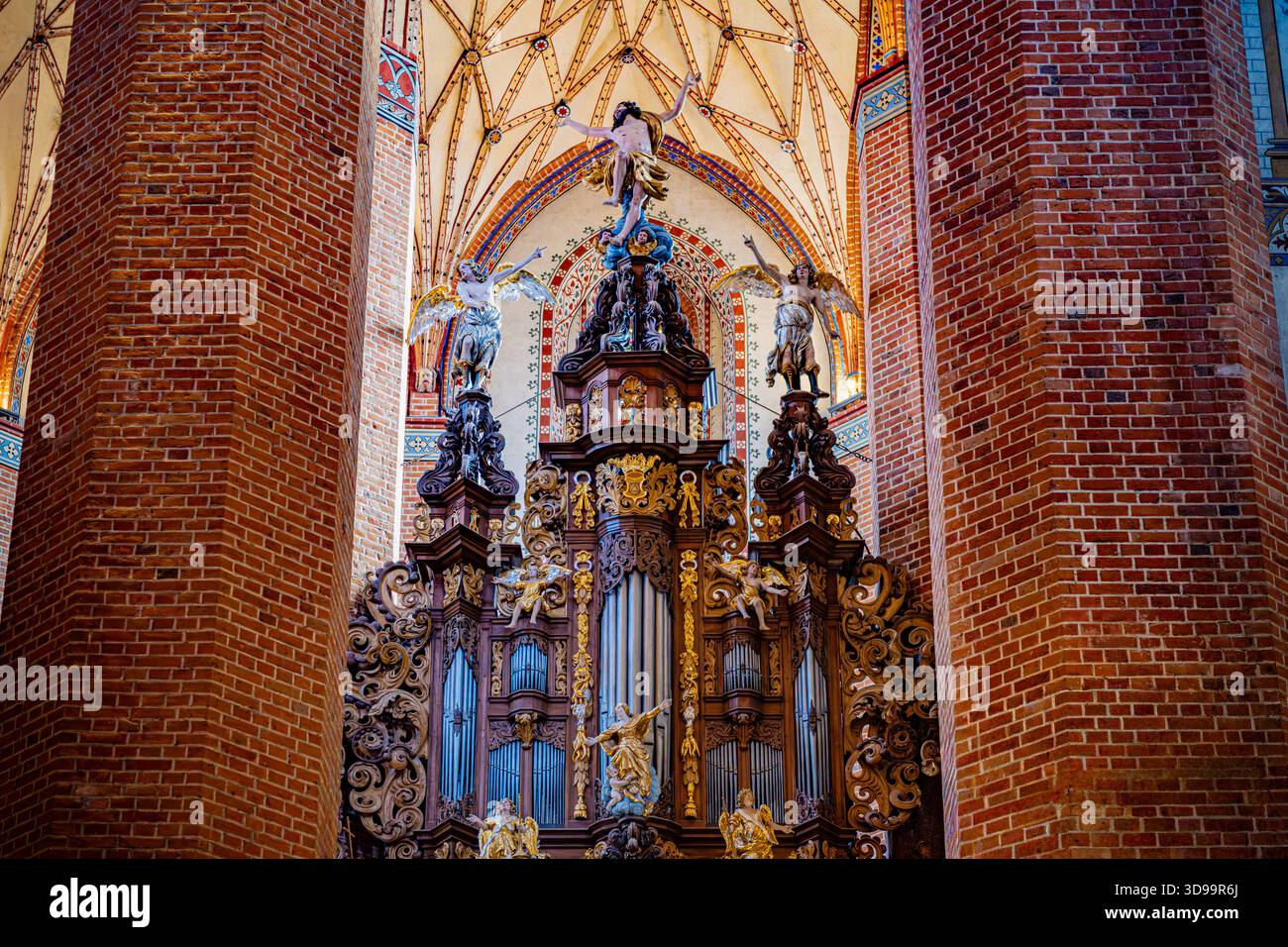 Ornate Baroque pipe organ with elaborate golden decorations in ...